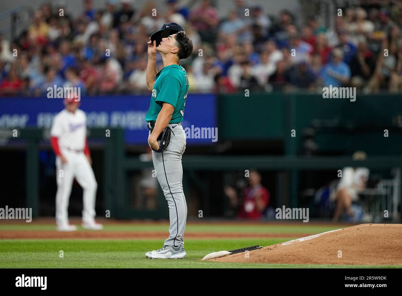 Seattle Mariners starting pitcher Bryan Woo stands by the mound before ...