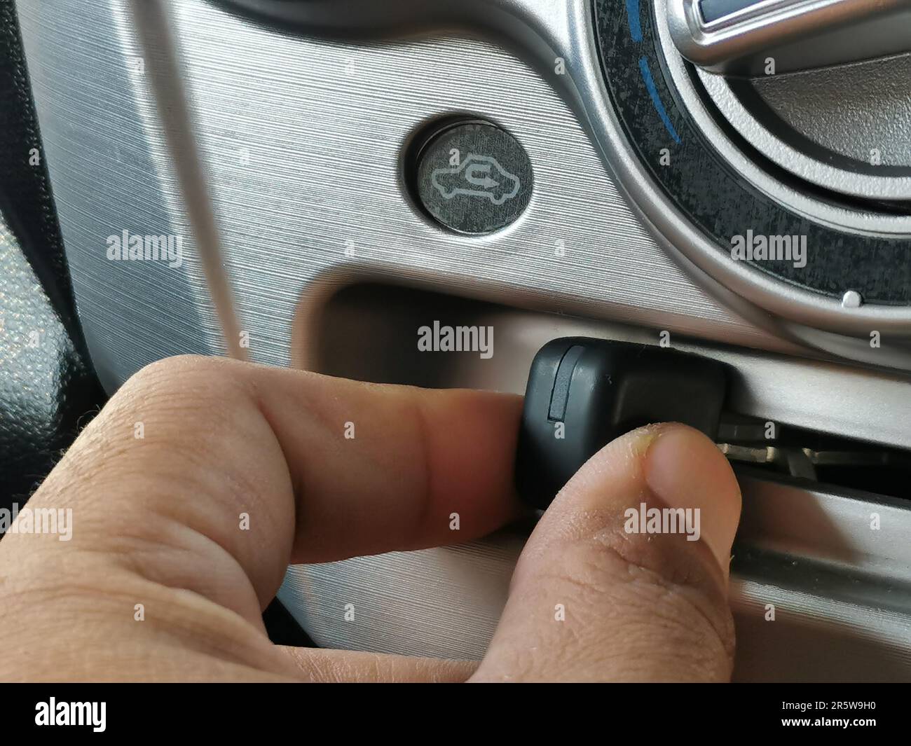 The hand adjusting airflow circulating button on the dashboard Stock ...