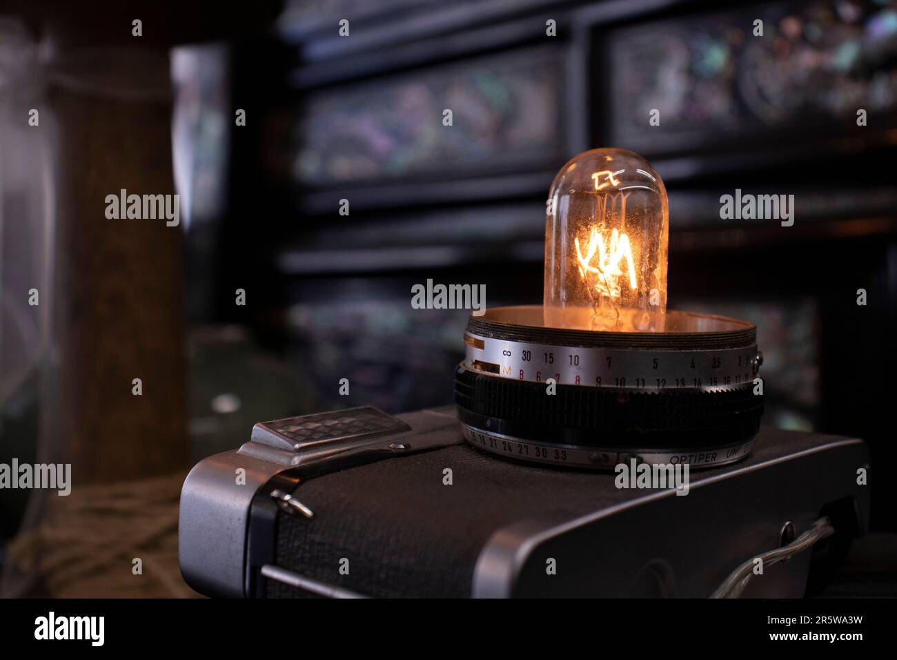 A light bulb on an old camera lens Stock Photo - Alamy