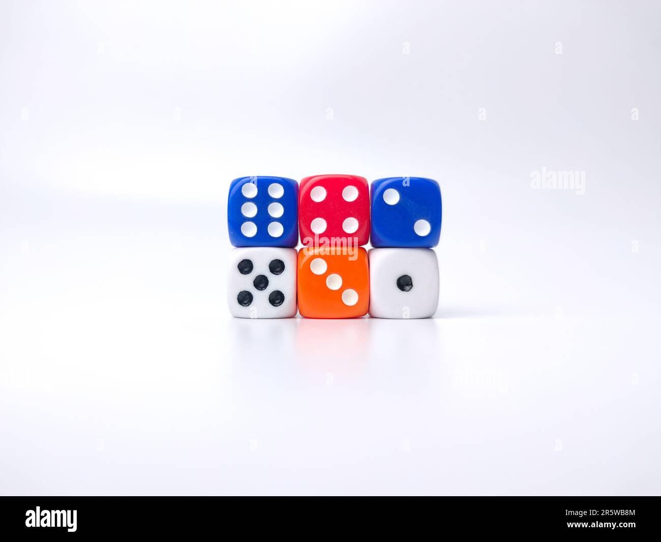 Six colorful dice cubes arranged in a single line against a white ...