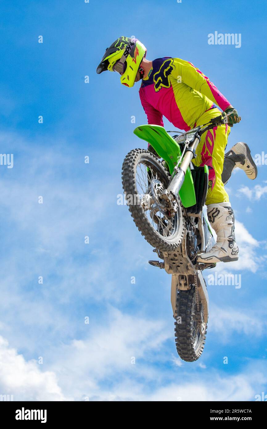 A low-angle shot of an enthusiastic motocross racer, jumping his ...