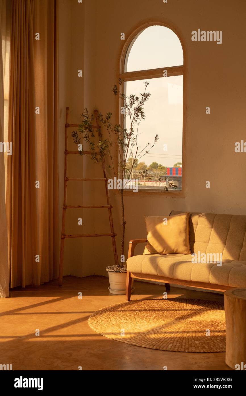 An interior scene of a cozy living room with a grand archway window ...