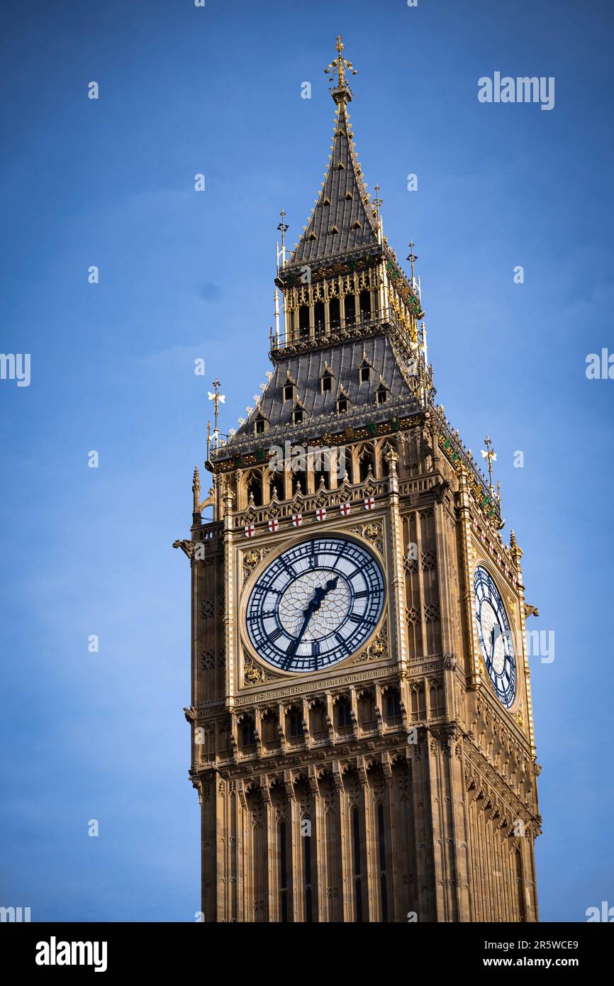 An impressive clock tower with elegant bell fixtures, set against a sky ...