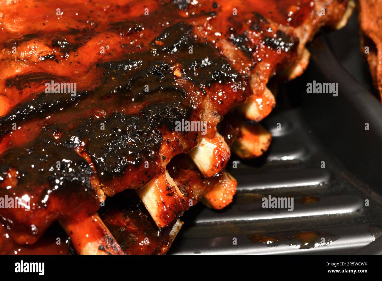 Barbequed spareribs in a plastic container. BBQ ribs Stock Photo - Alamy