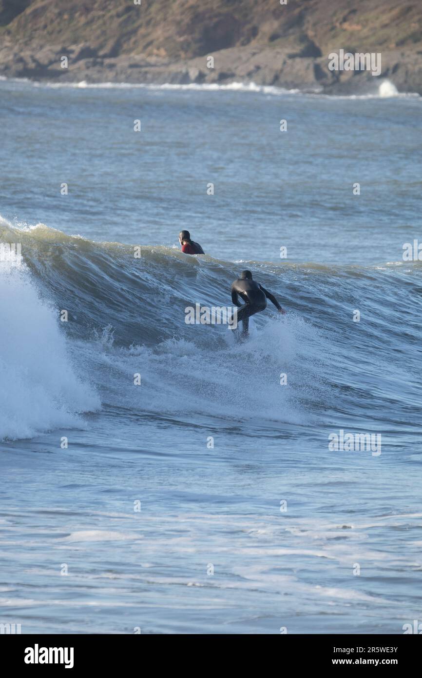 The surfers riding the waves on their surfboards Stock Photo - Alamy
