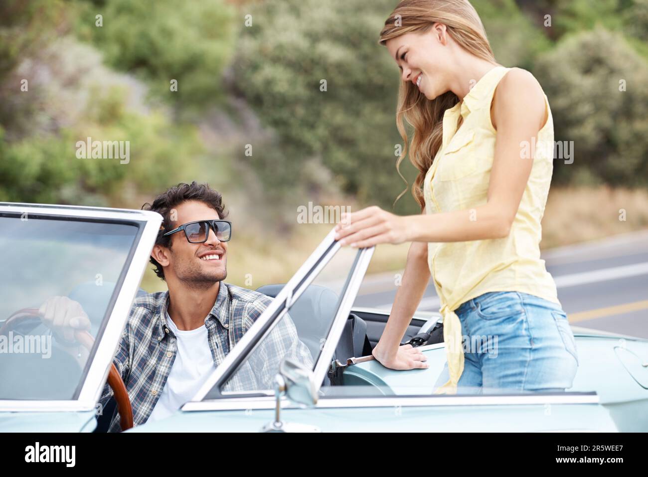 Can I catch a ride. An attractive young guy picking up a cute girl in ...