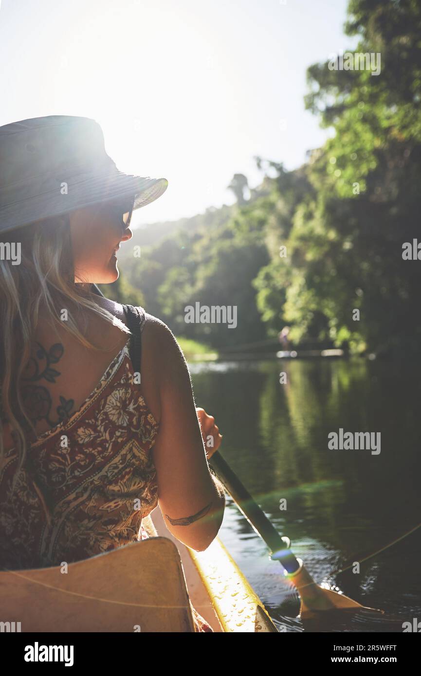 Life teaches you to just go with the flow. a young woman out kayaking ...