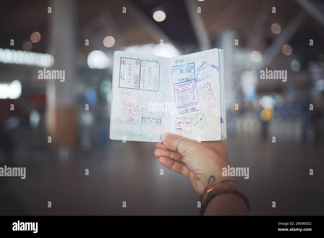 Catching flights not feelings. a woman showing her passport stamps at ...