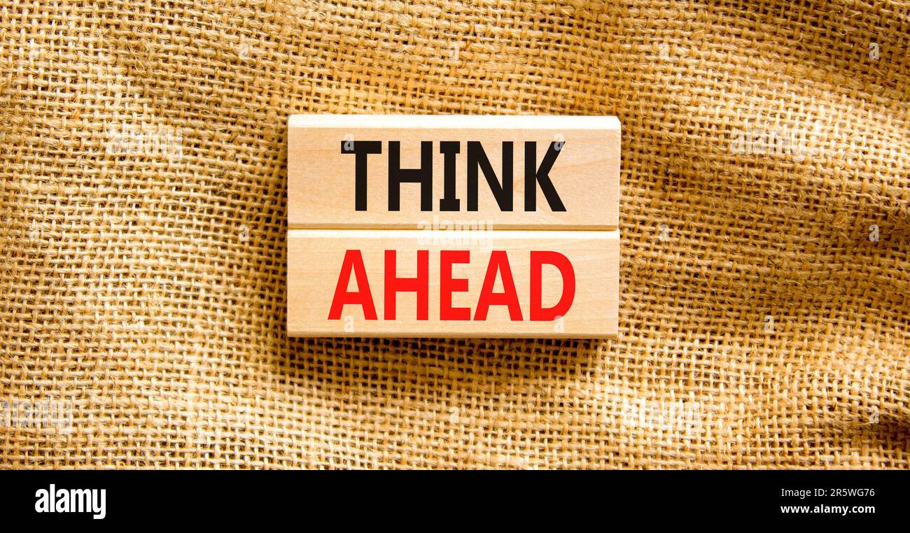 Think ahead symbol. Concept words Think ahead on wooden blocks on a beautiful canvas table ...