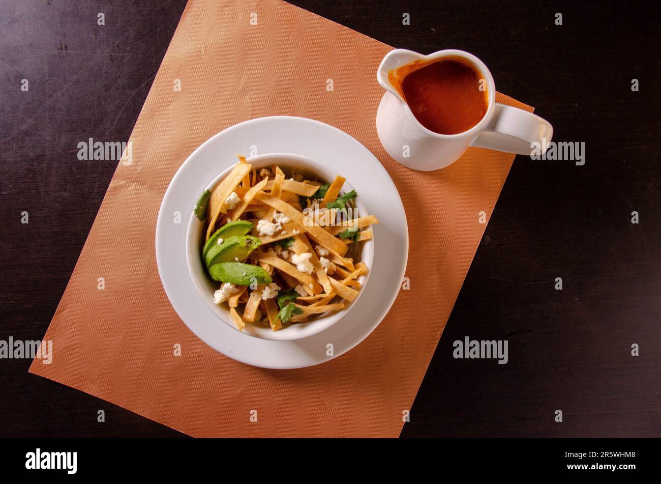 Aztec Soup Mexican Food Cenital served with a red sauce on the table ...