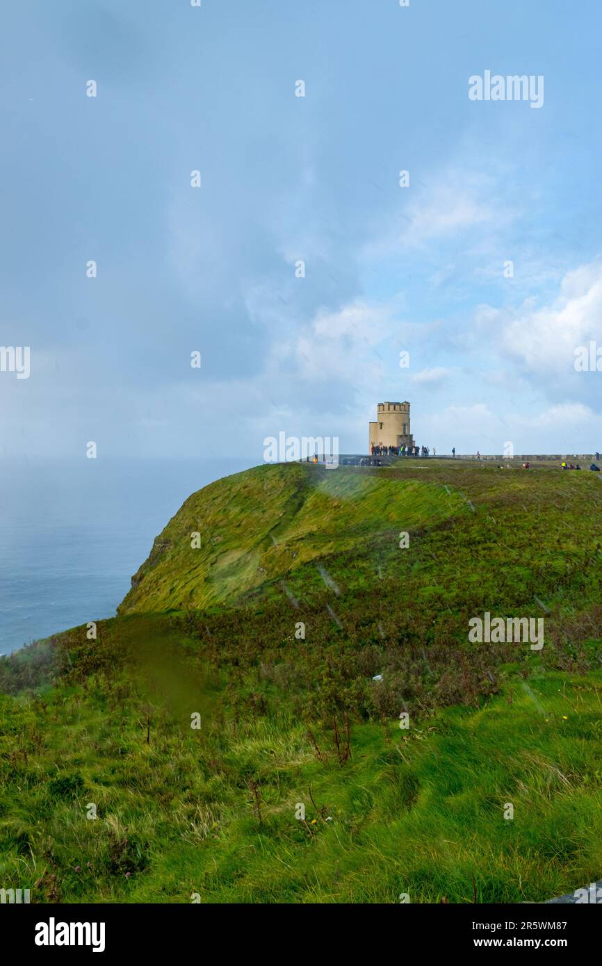An aerial view of a grassy hill with a large tower situated atop of it ...