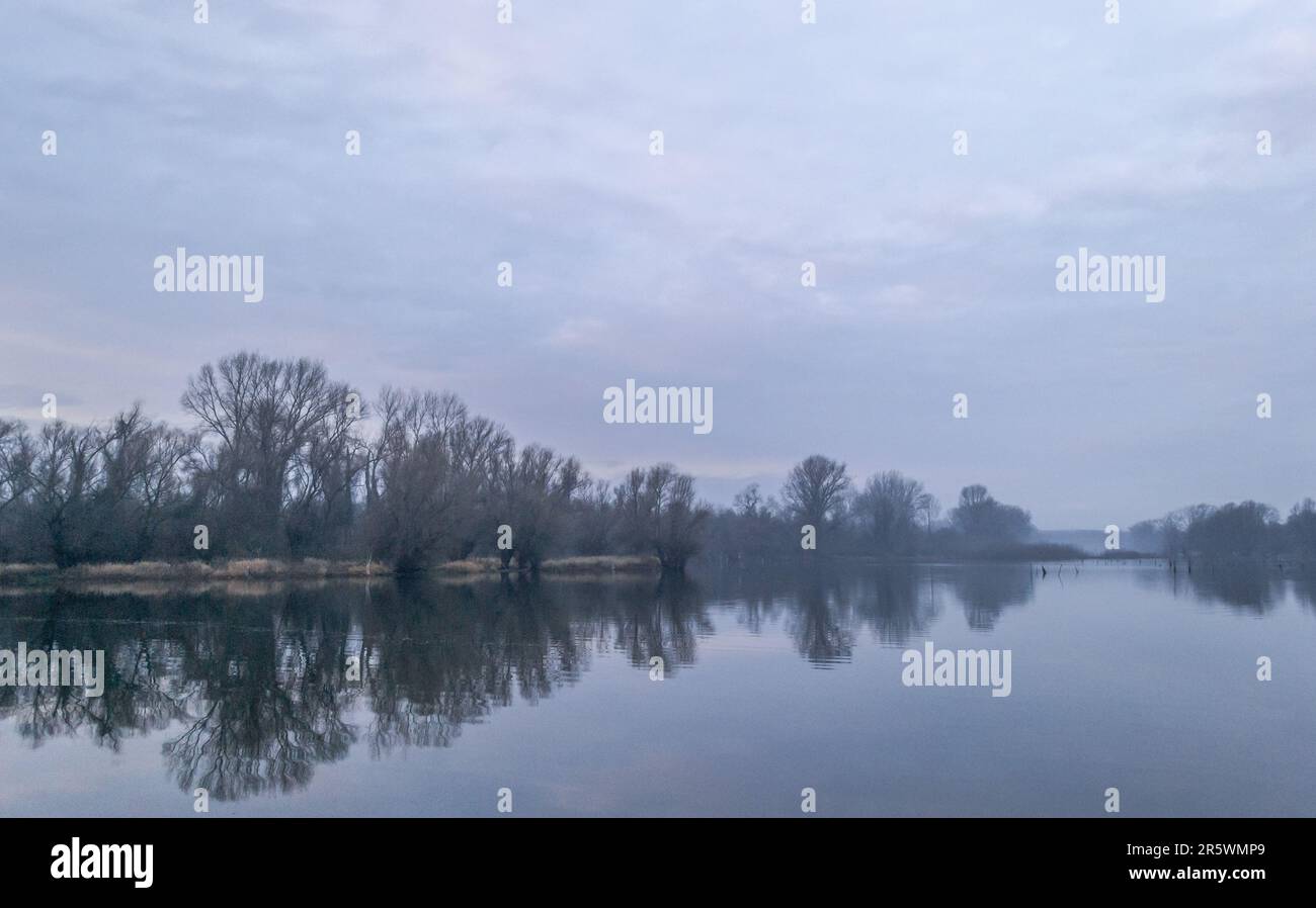 A vast body of water stretching into the horizon, the lake is filled to ...