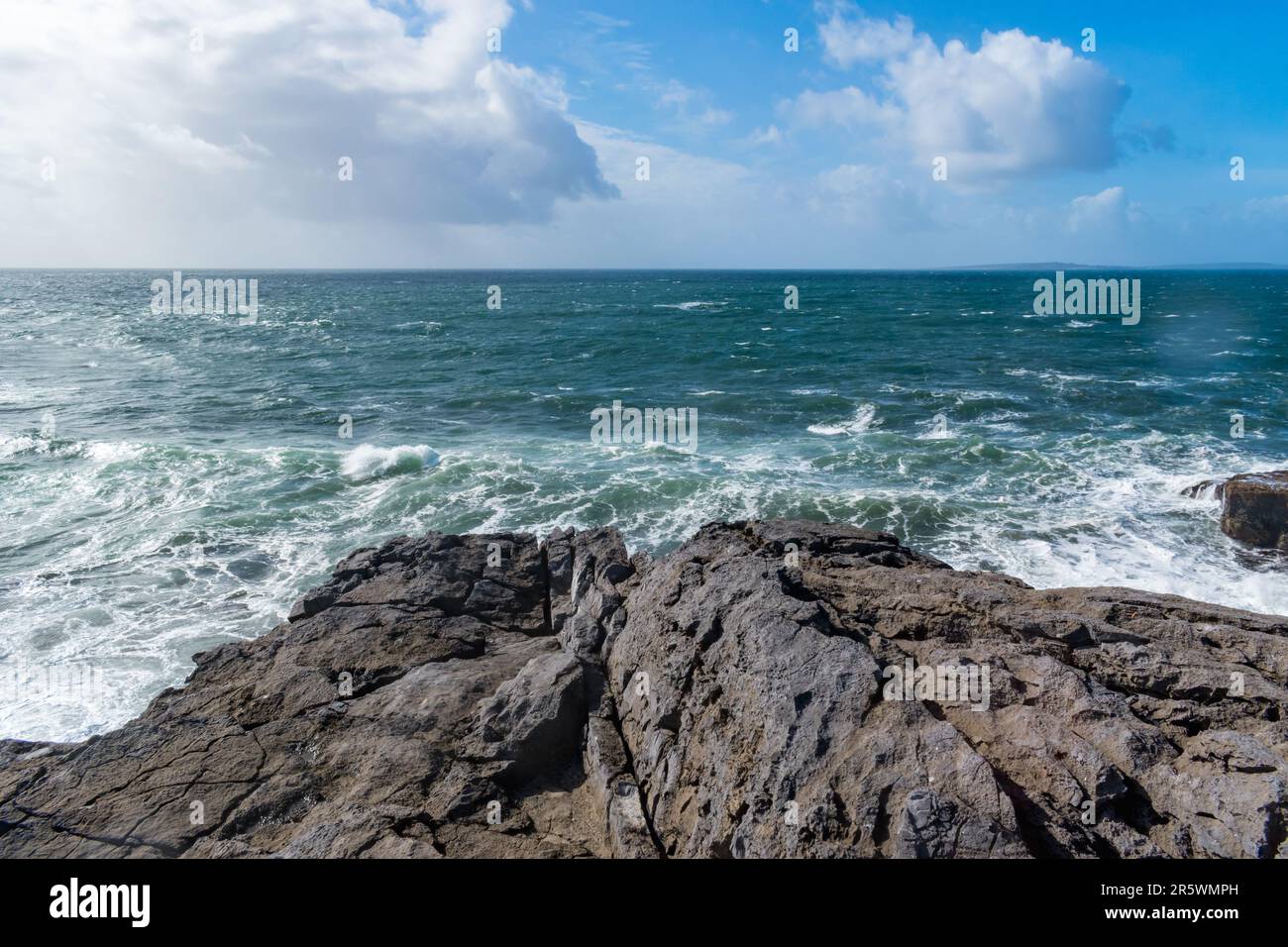 A beautiful seascape featuring crashing waves against a rocky shoreline ...