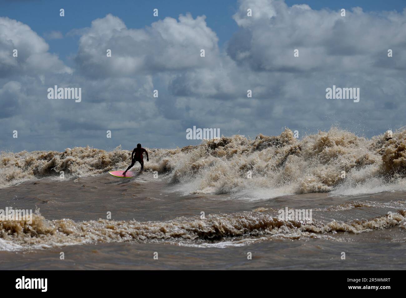 Brazilian surfer Naysson Costa rides the tidal bore wave known as ...