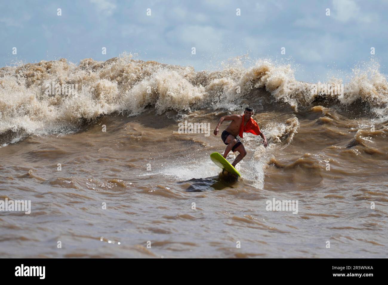 Brazilian surfer Naysson Costa rides the tidal bore wave known as ...