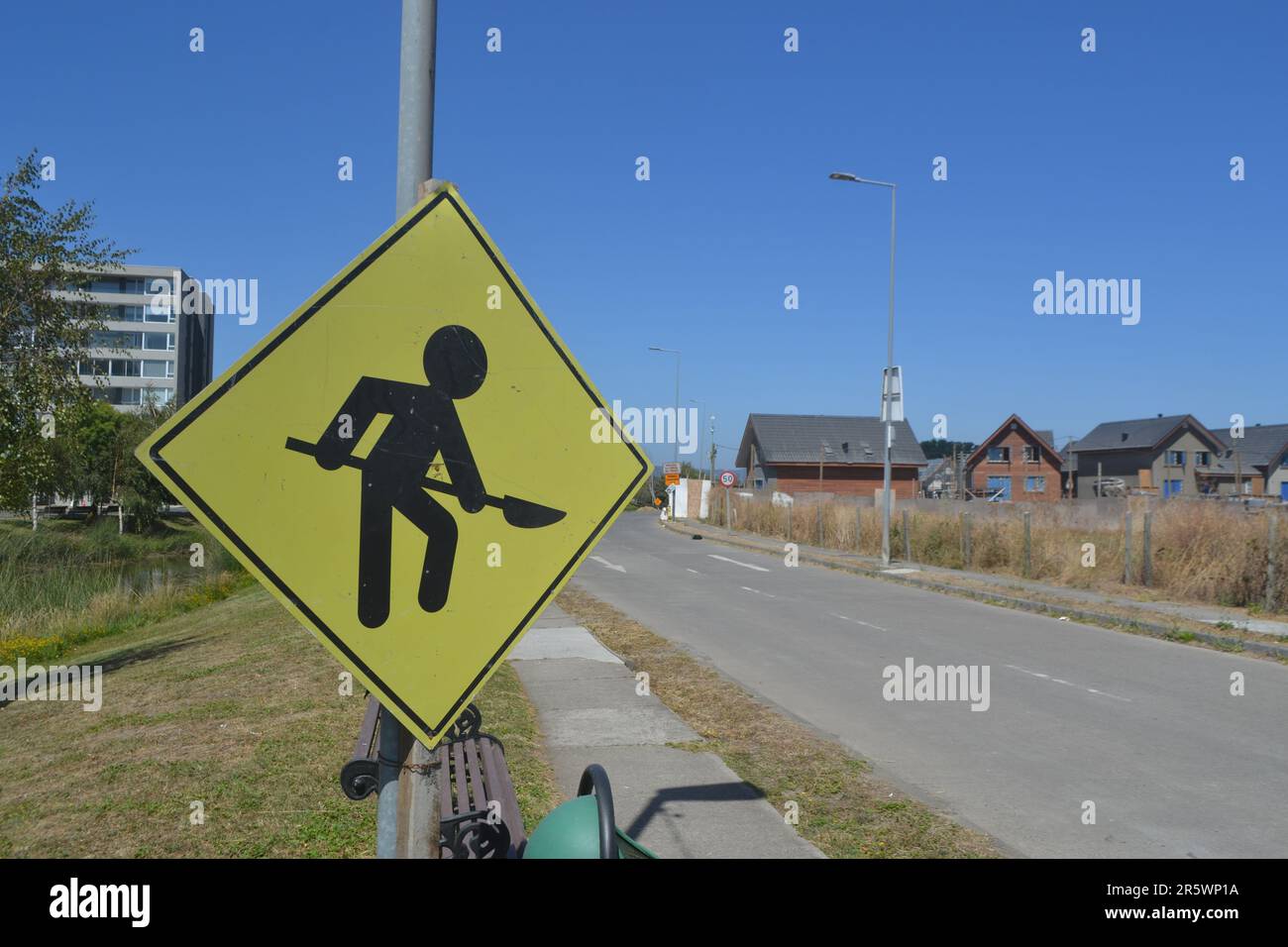 A yellow construction site sign on a street Stock Photo - Alamy