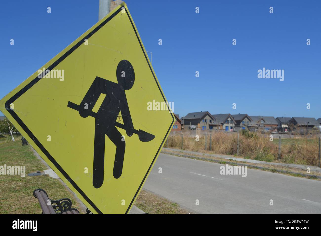 A yellow construction site sign on a street Stock Photo - Alamy