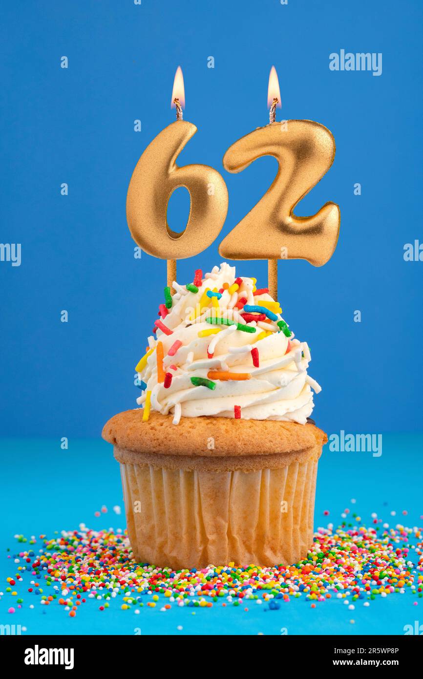 Birthday cake with candle number 62 - Blue background Stock Photo - Alamy