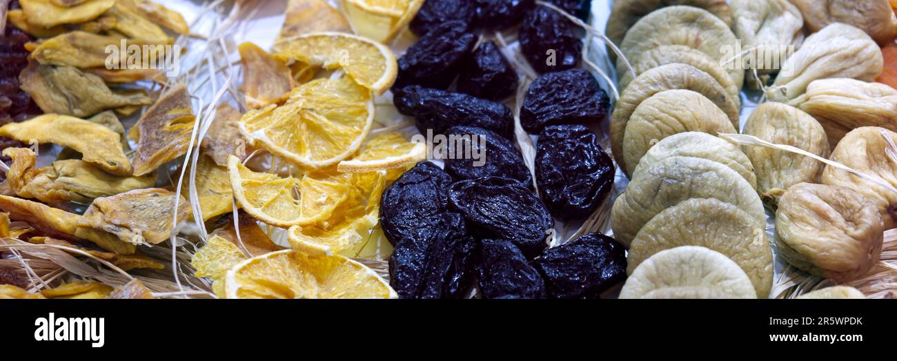 Dried fruit background. Rows of dried dates, apricots, lemon, prunes ...