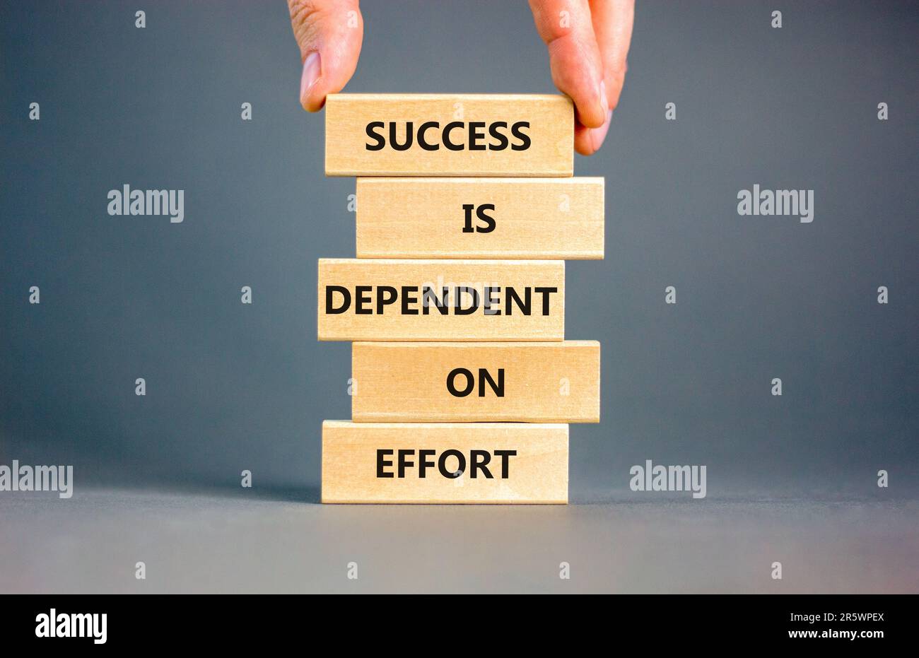 Success and effort symbol. Concept words Success is dependent on effort ...