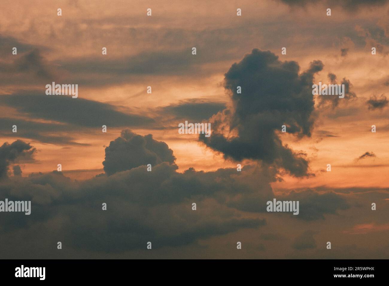 This image features a dark sky full of clouds, creating a dramatic and ...