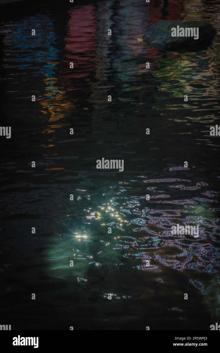 A scenic coastal landscape featuring a body of water with a light ...