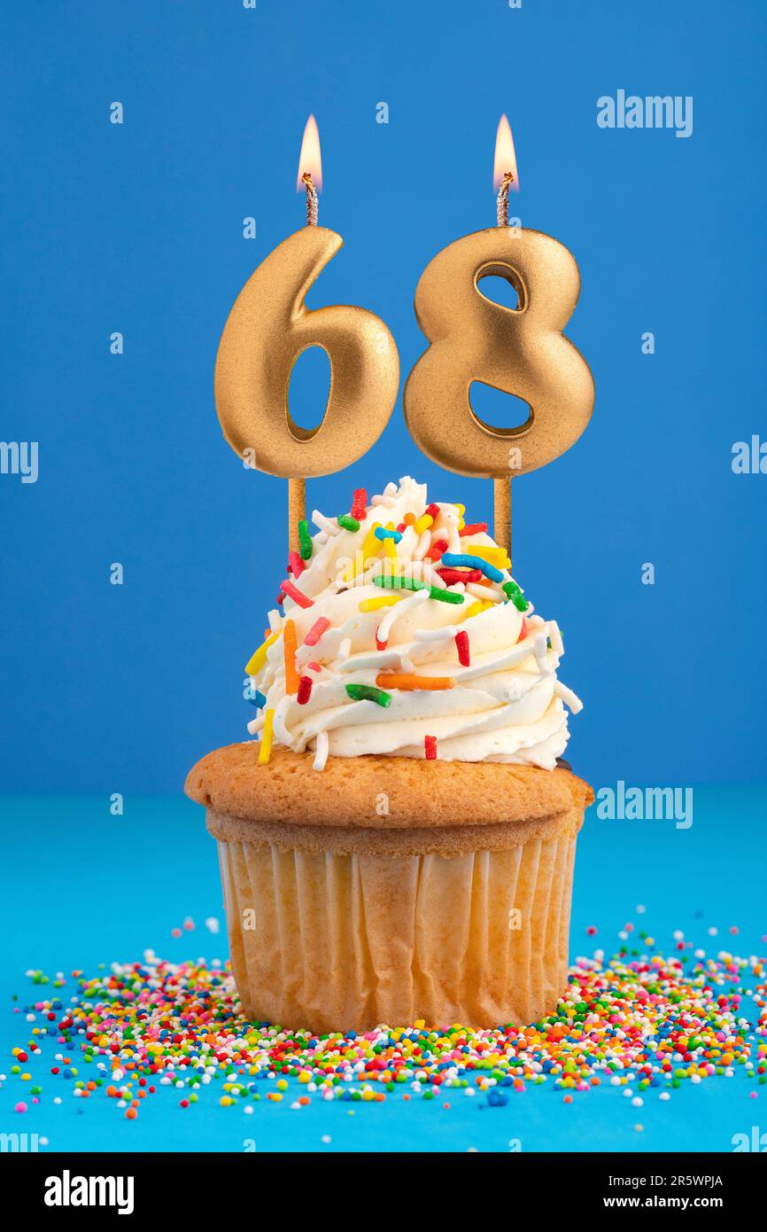 Birthday cake with candle number 68 - Blue background Stock Photo - Alamy