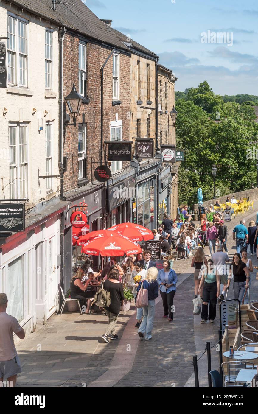 Visitors to Durham City sitting outside bars on Elvet Brdige, Co ...