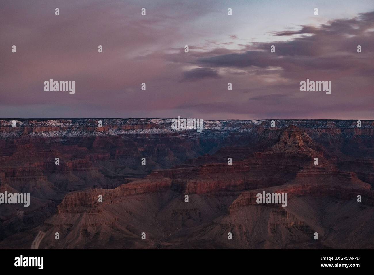 A stunning landscape featuring two white clouds in a vibrant blue sky ...