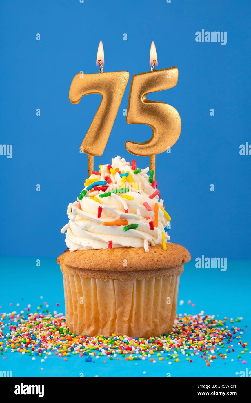 Candle number 75 - Cake birthday in blue background Stock Photo - Alamy