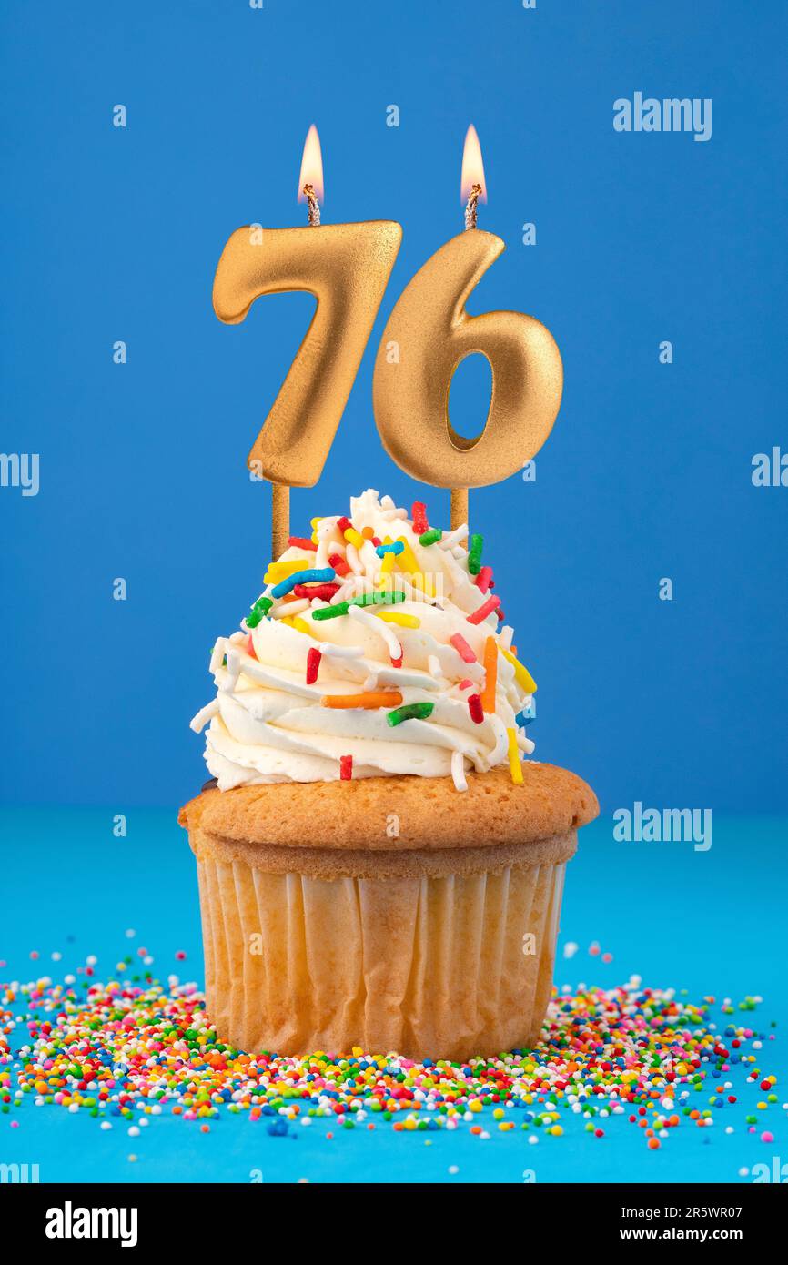 Birthday cake with candle number 76 - Blue background Stock Photo - Alamy