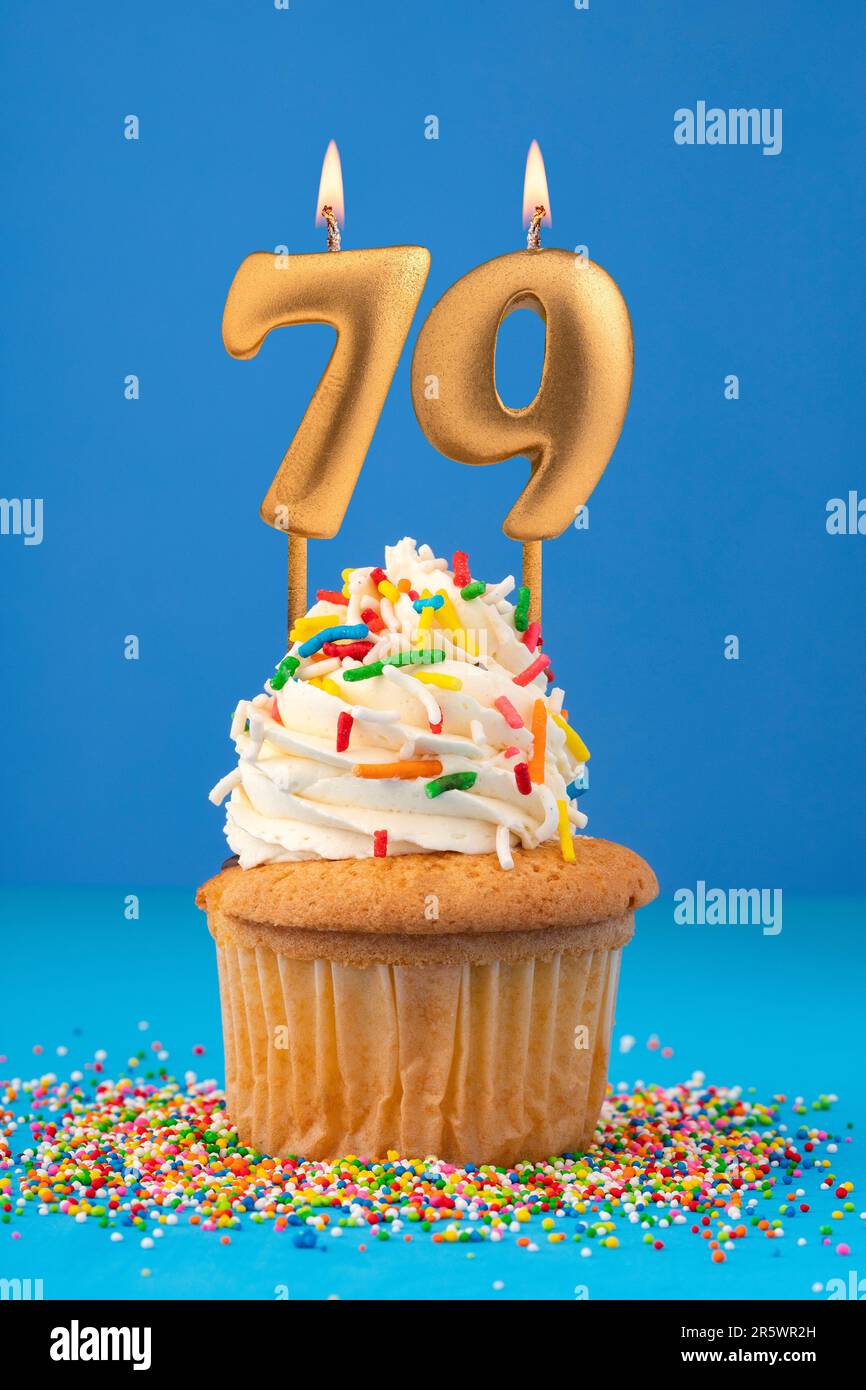 Candle number 79 - Cake birthday in blue background Stock Photo - Alamy