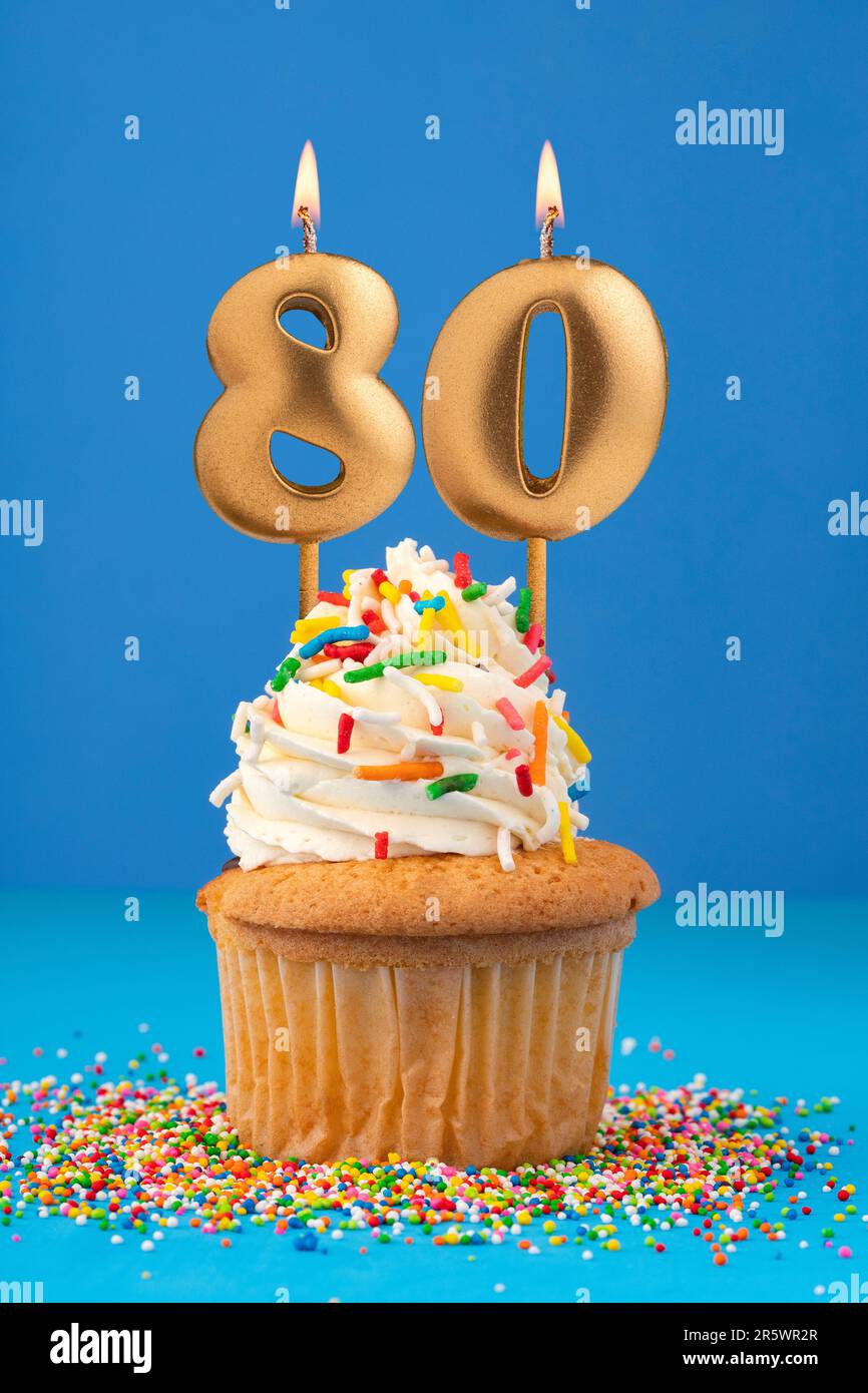 Birthday cake with candle number 80 - Blue background Stock Photo - Alamy