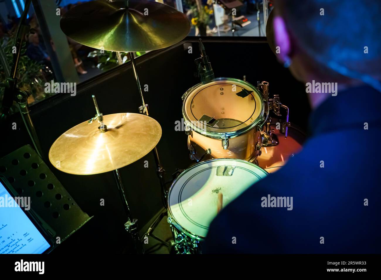 A man performs electronic music using an array of electronic musical ...