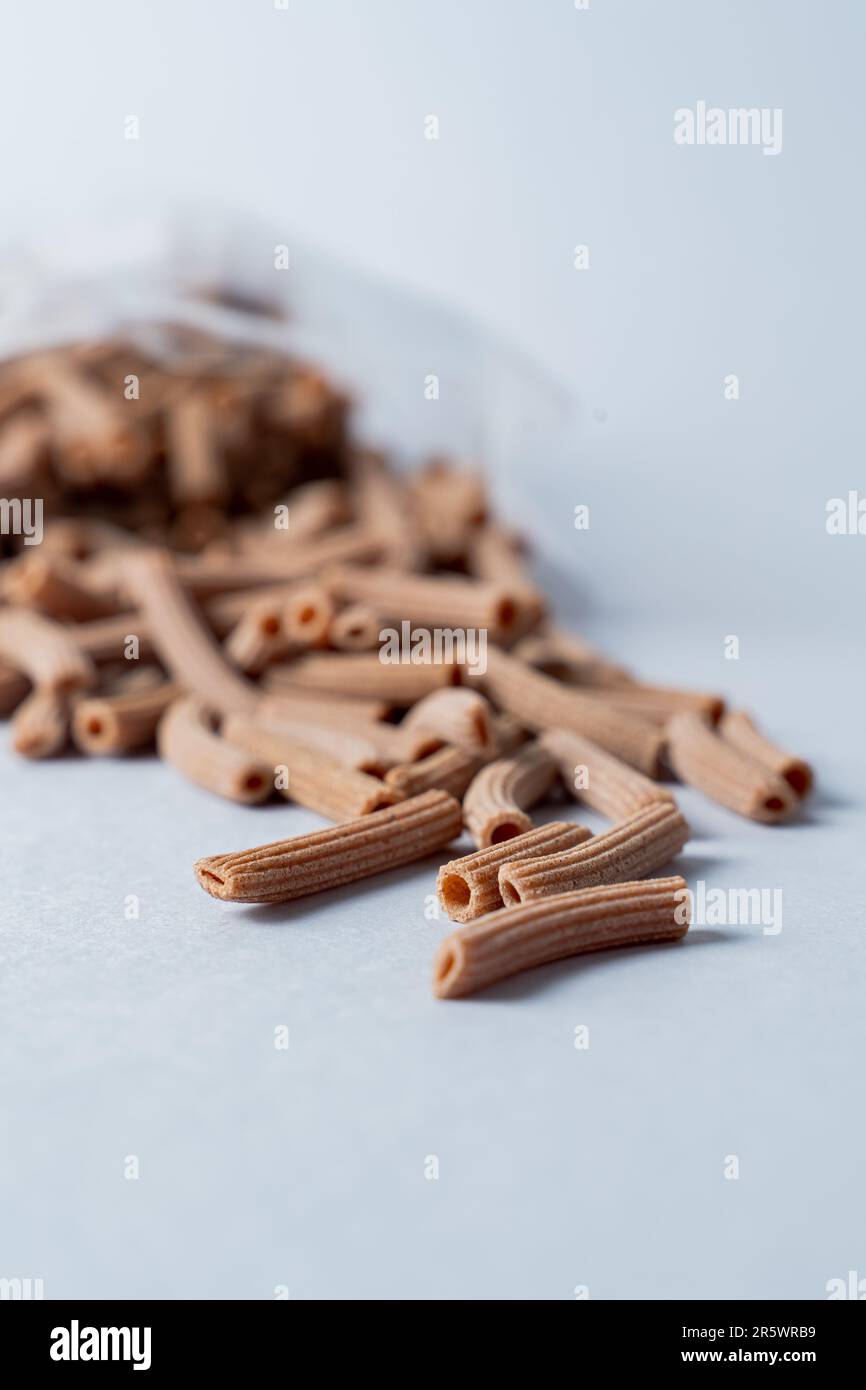 A variety of cooked pasta pieces of different shapes and sizes arranged ...