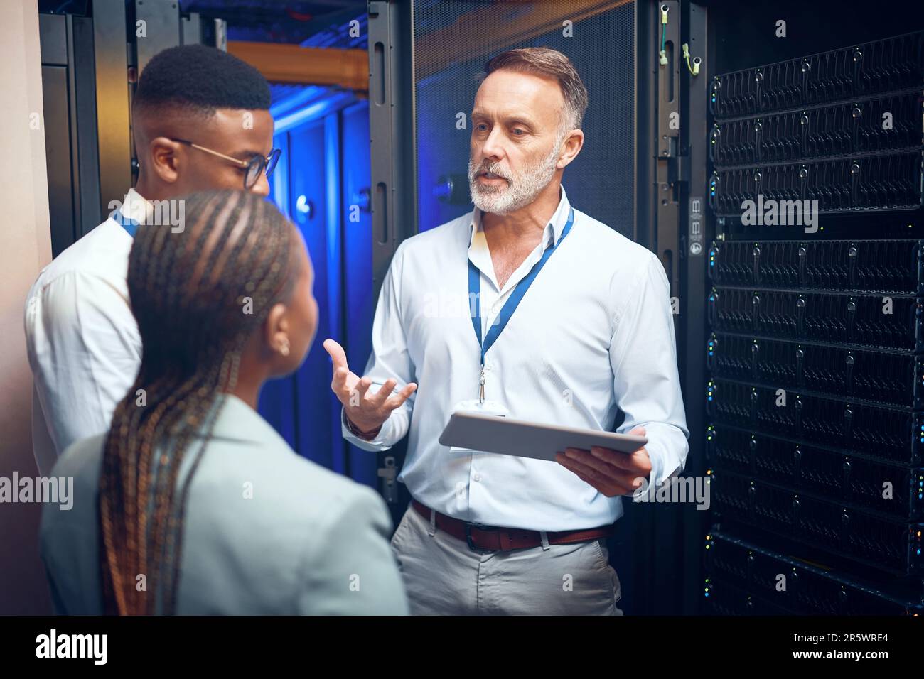 Building and maintaining big data infrastructure. a group of technicians using a digital tablet ...