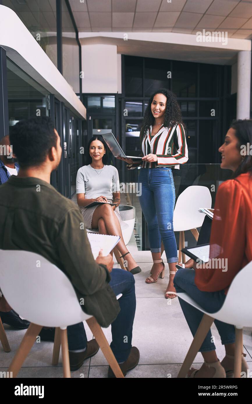 Working together is a success. a young businesswoman holding her laptop ...