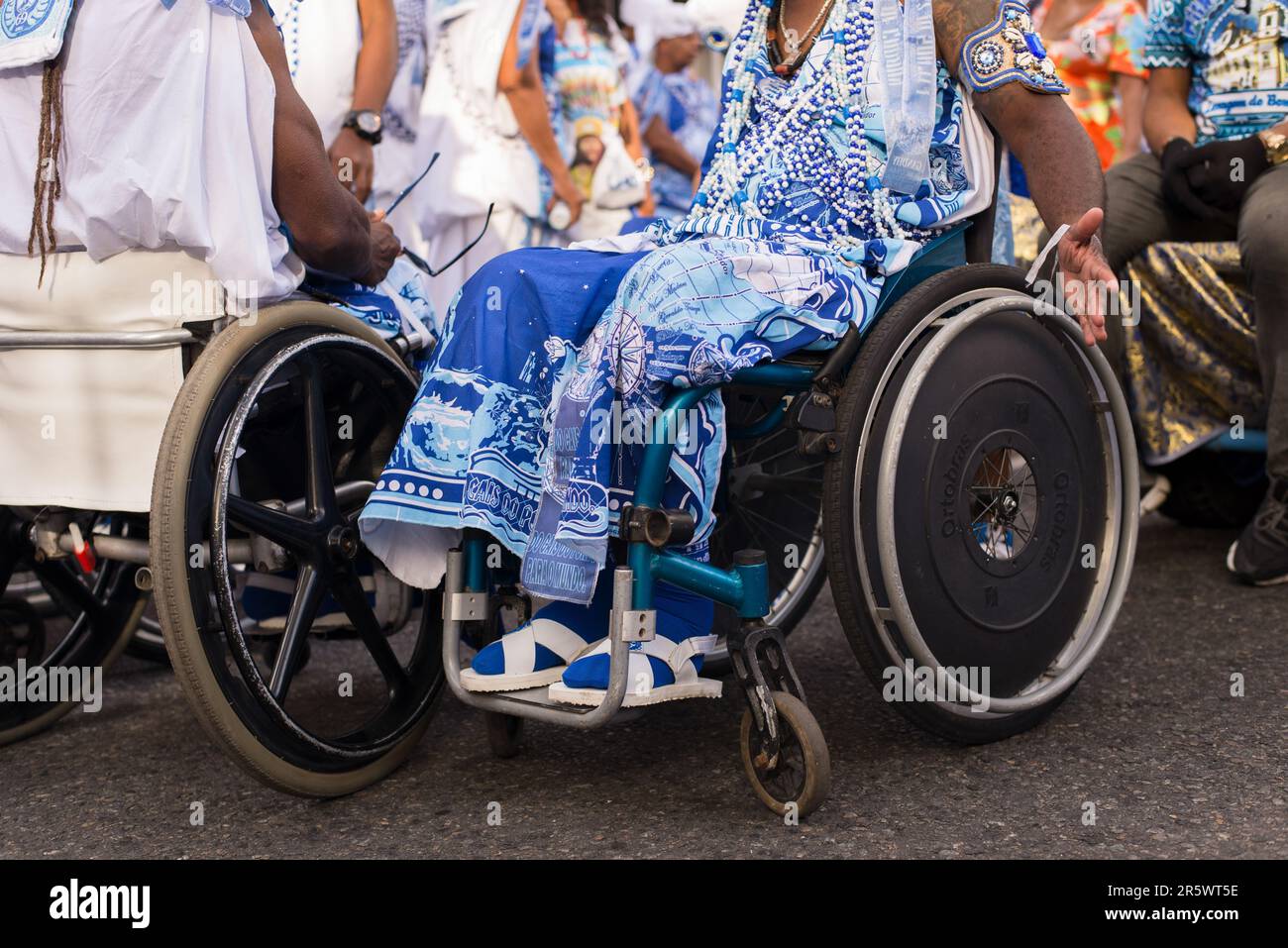 Two individuals in wheelchairs are sitting side-by-side in a cheerful ...