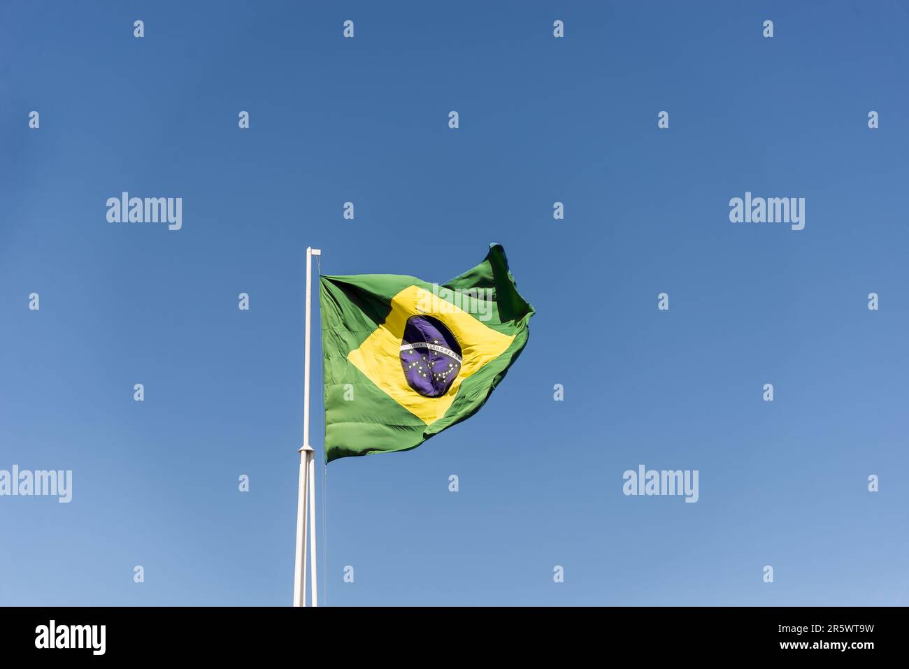 A high-resolution image of a colorful flag flapping in the wind as it ...