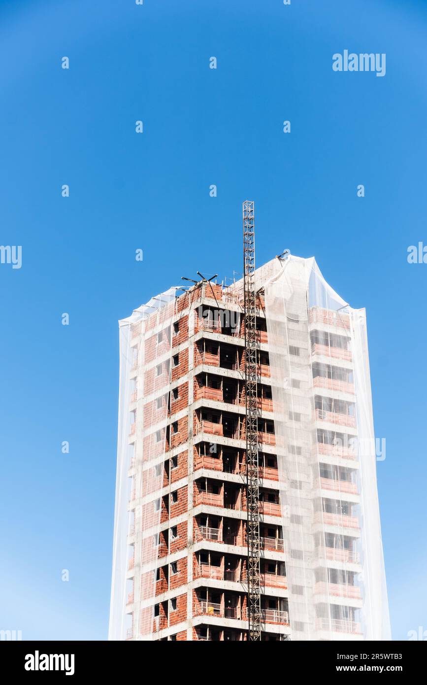 A towering skyscraper stands prominently in a bustling metropolis, surrounded by an array of ...