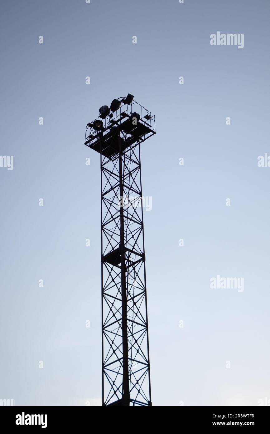 A tall TV tower structure stands tall against the backdrop of a bright ...