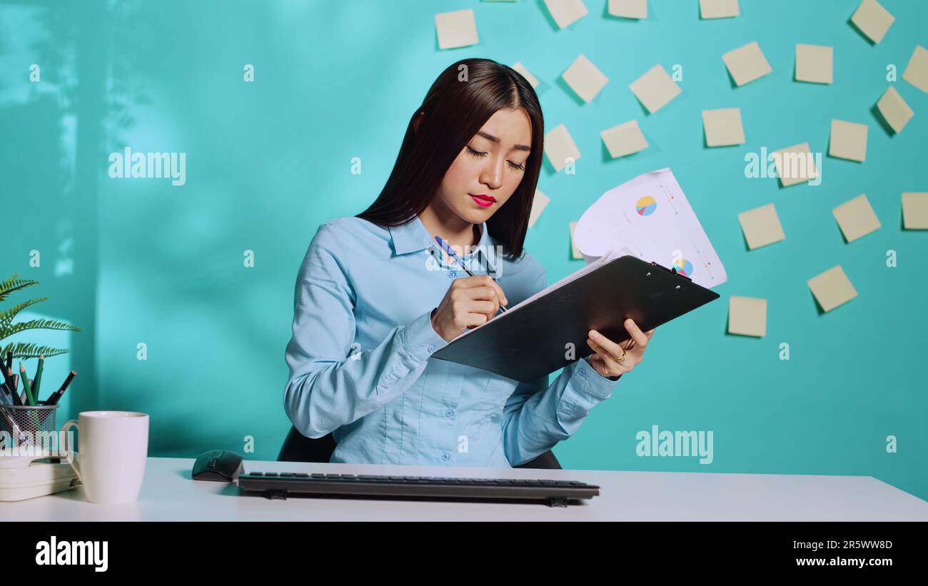 Timelapse of asian businesswoman going thorugh the motions in typical ...