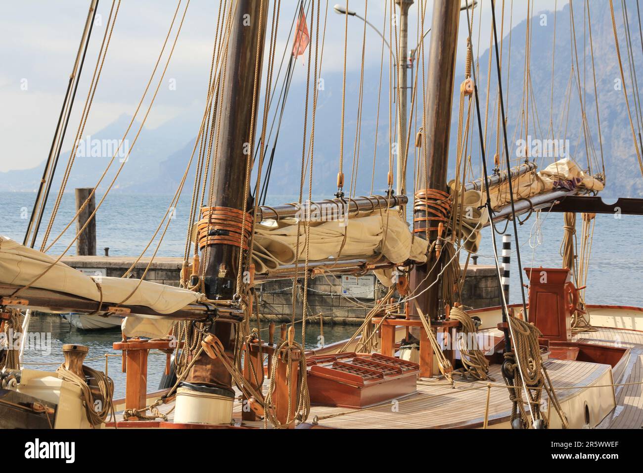 A majestic tall sailing ship departing from a dock, with ropes ...