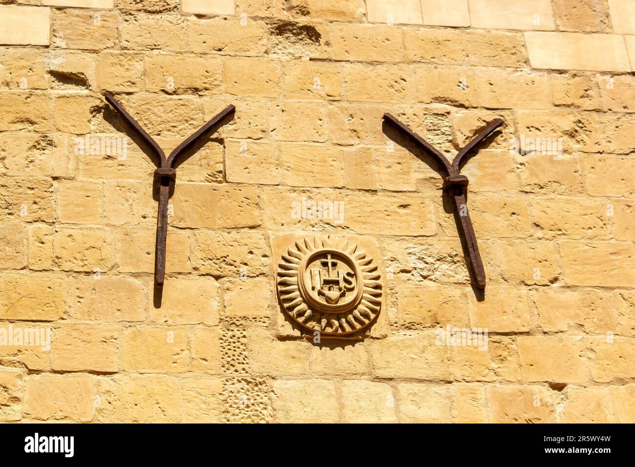 The IHS stone emblem and two iron Y shapes decorating the back of the ...