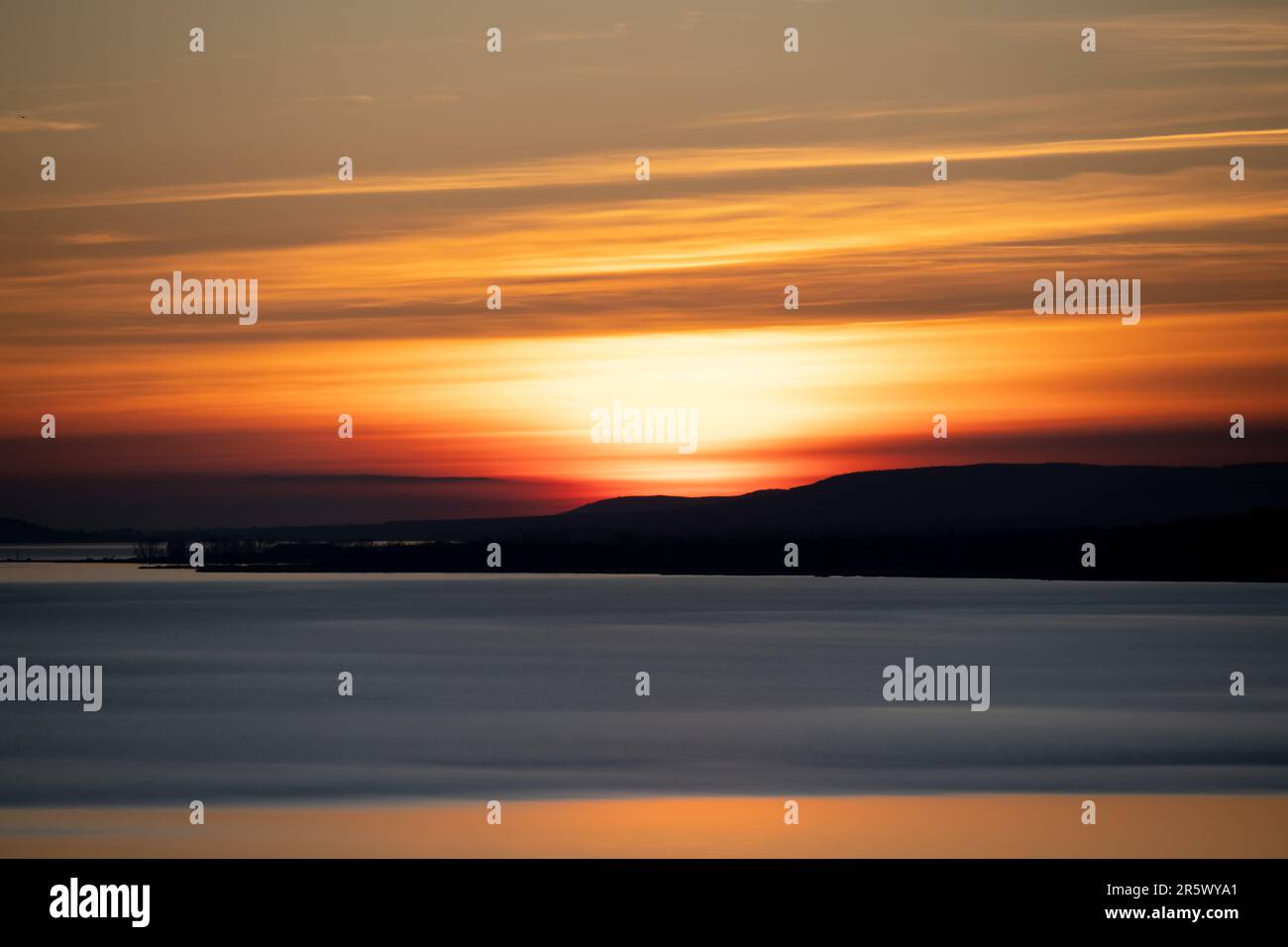 A breathtaking view of a golden sunset over the horizon of the ocean ...
