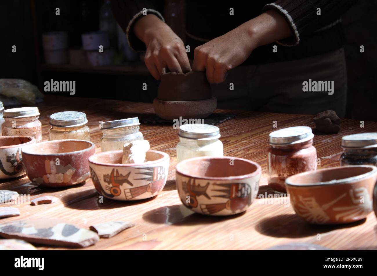 A wooden table with traditional Peruvian pottery samples Stock Photo ...
