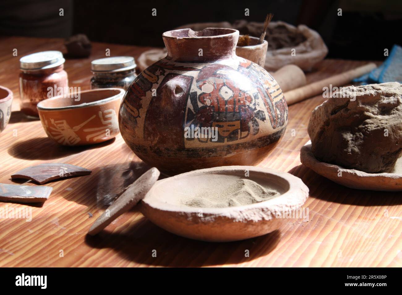 A wooden table with traditional Peruvian pottery samples Stock Photo ...