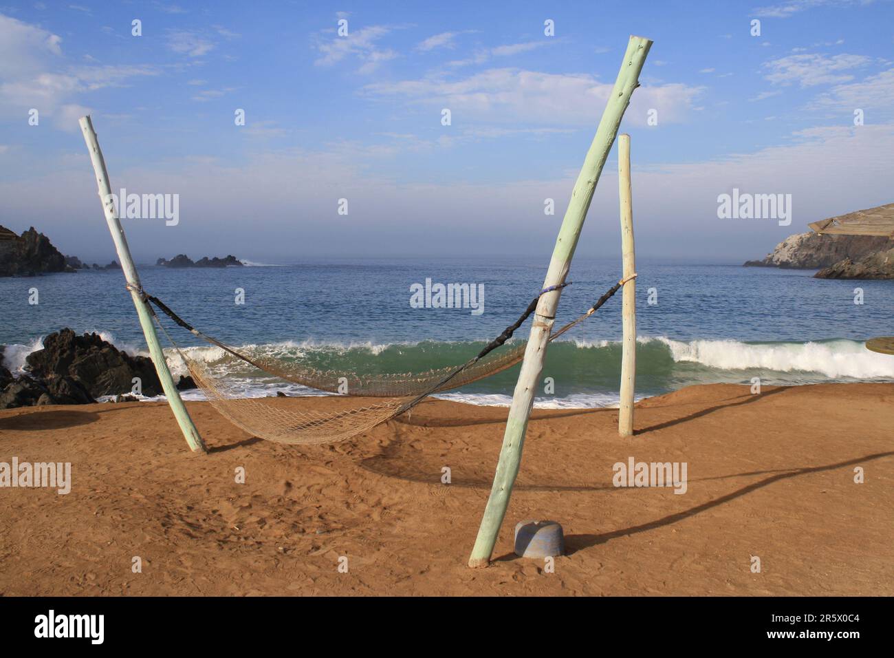 The wooden posts with hammocks on a sandy beach in Peru Stock Photo - Alamy