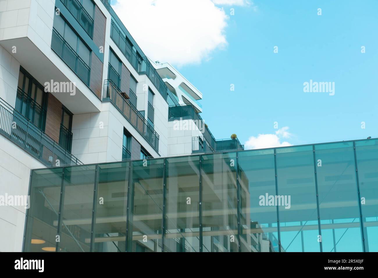 A modern office building with a glass entrance featuring a set of ...