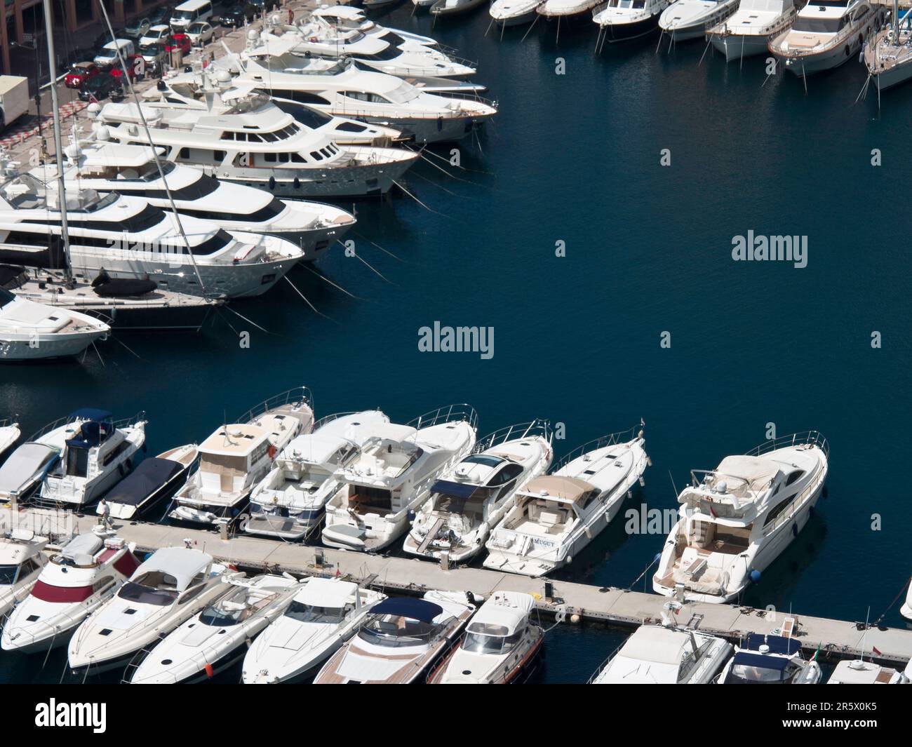 A vibrant aerial view of a harbor showcasing a fleet of boats moored in ...